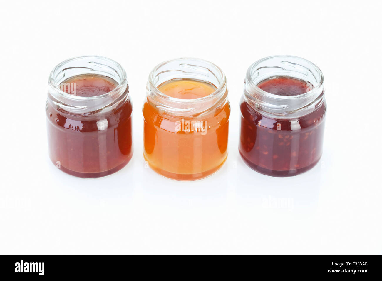 Variety of jam on white background, close up Stock Photo - Alamy
