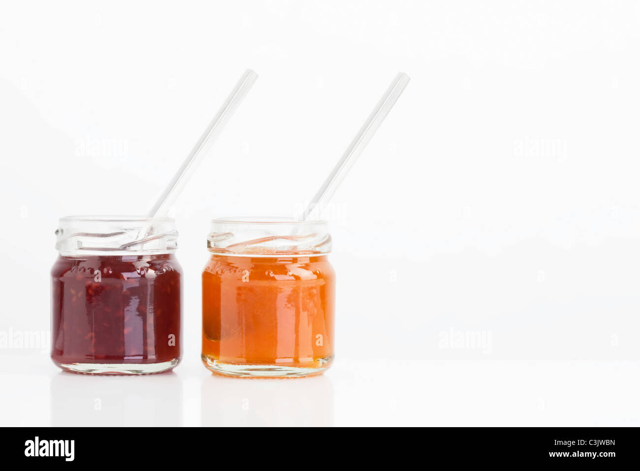 Spoon in jam jar on white background Stock Photo - Alamy