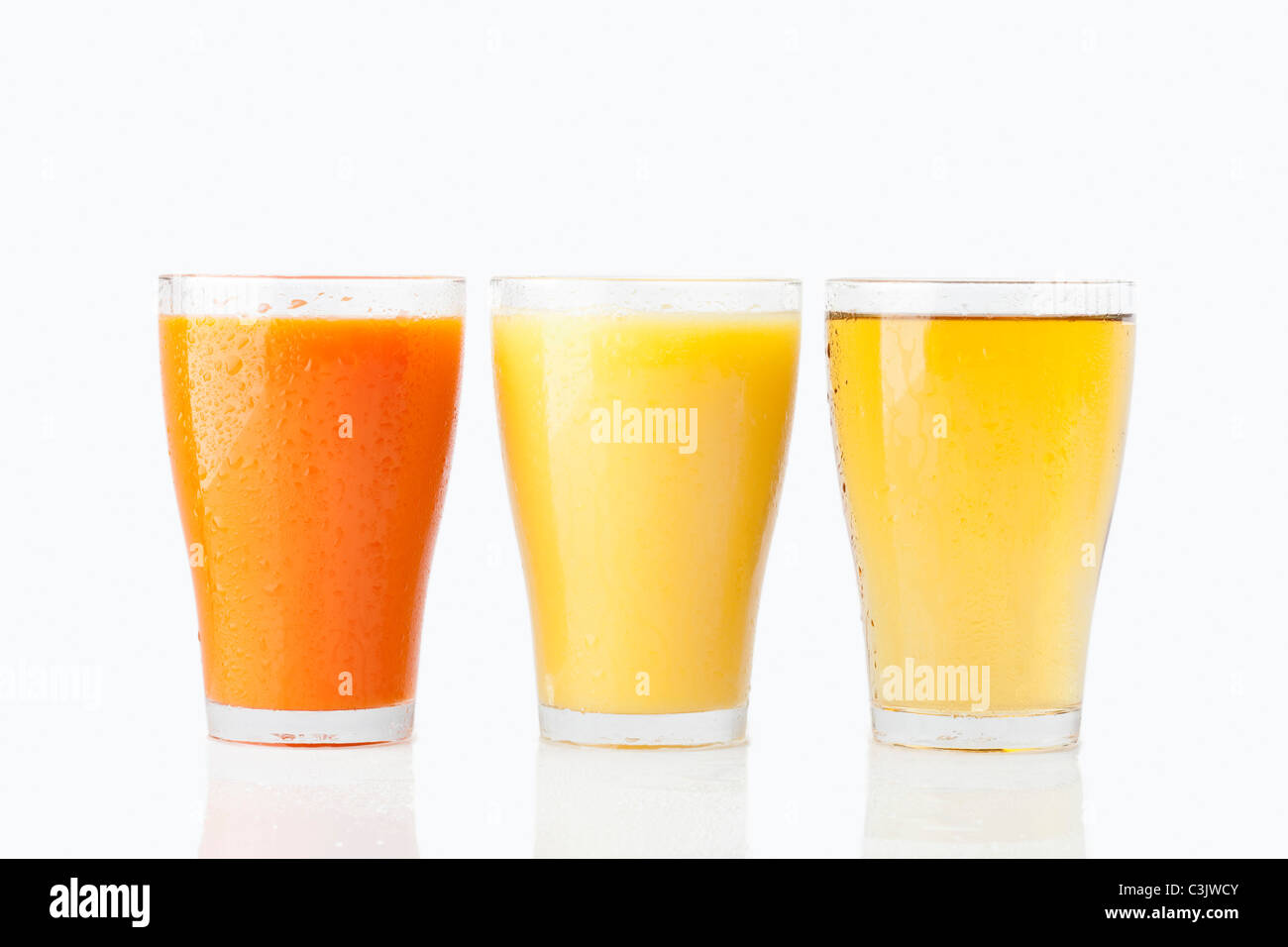 Variety of juices in glass on white background Stock Photo - Alamy