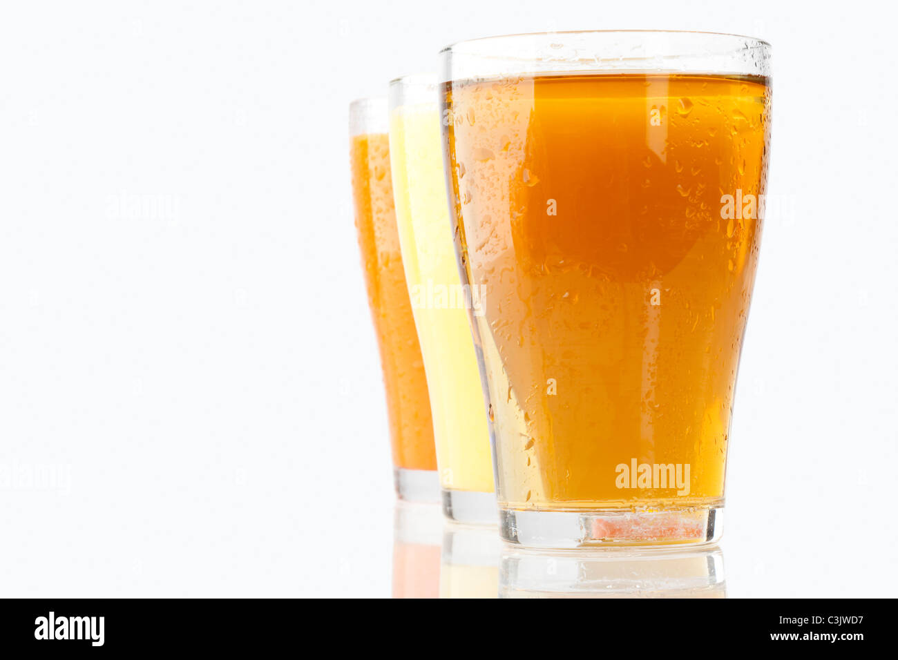 Variety of juices in glass on white background Stock Photo - Alamy