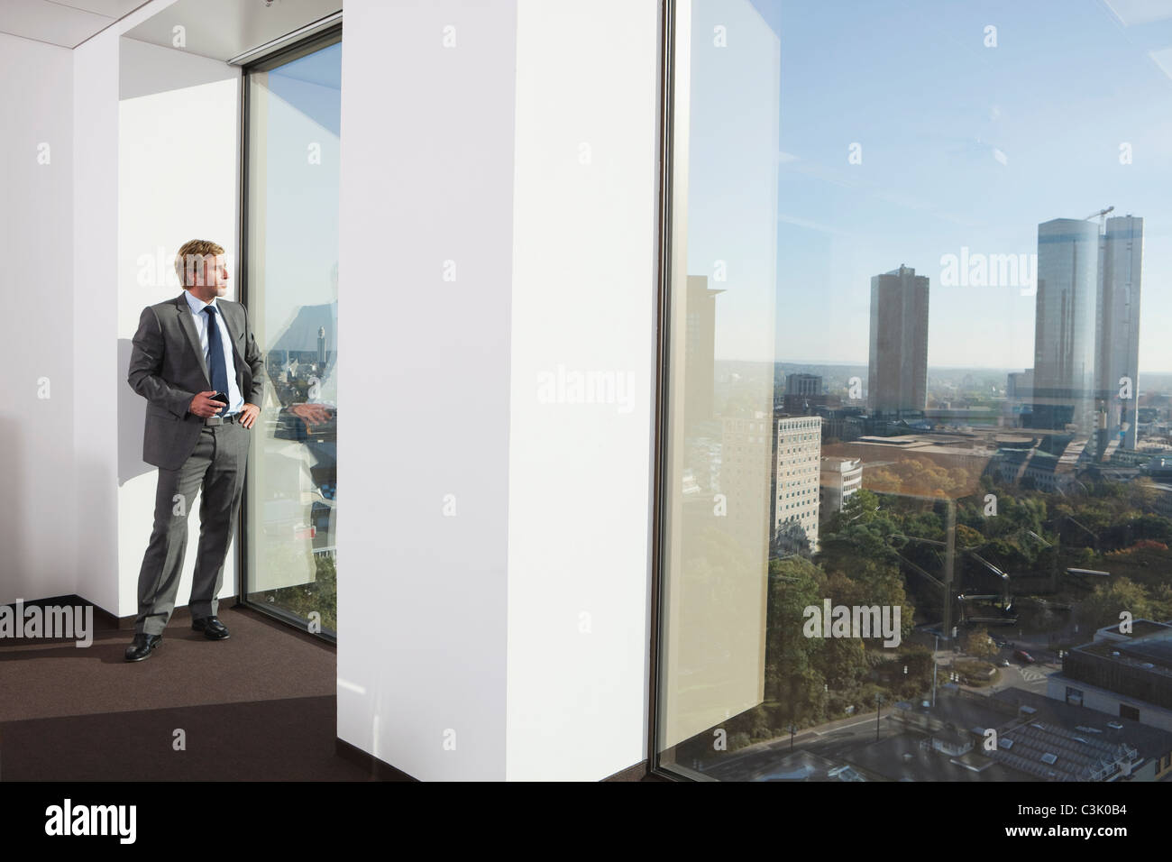 Germany, Frankfurt, Businessman using phone in office Stock Photo - Alamy