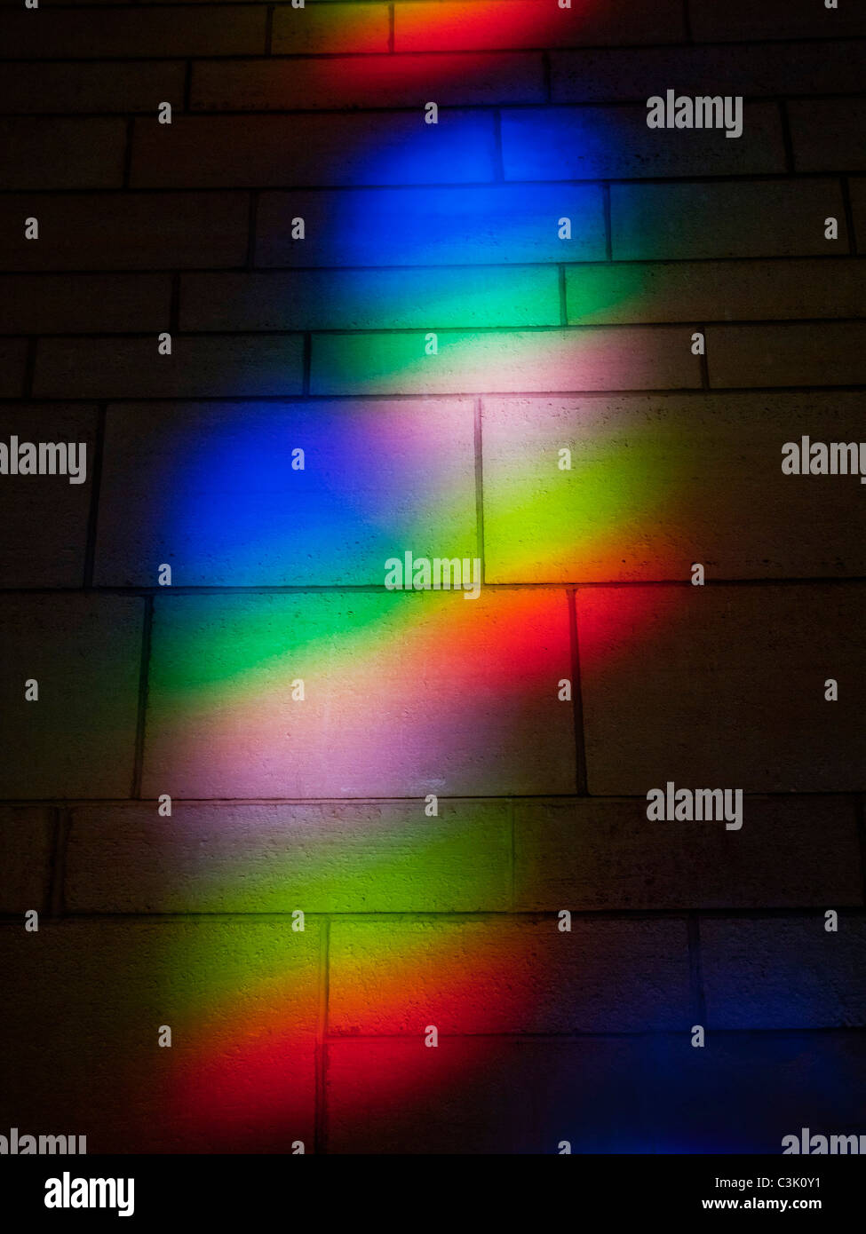 Sunlight refracted through a window forms a spectrum on a wall in ...