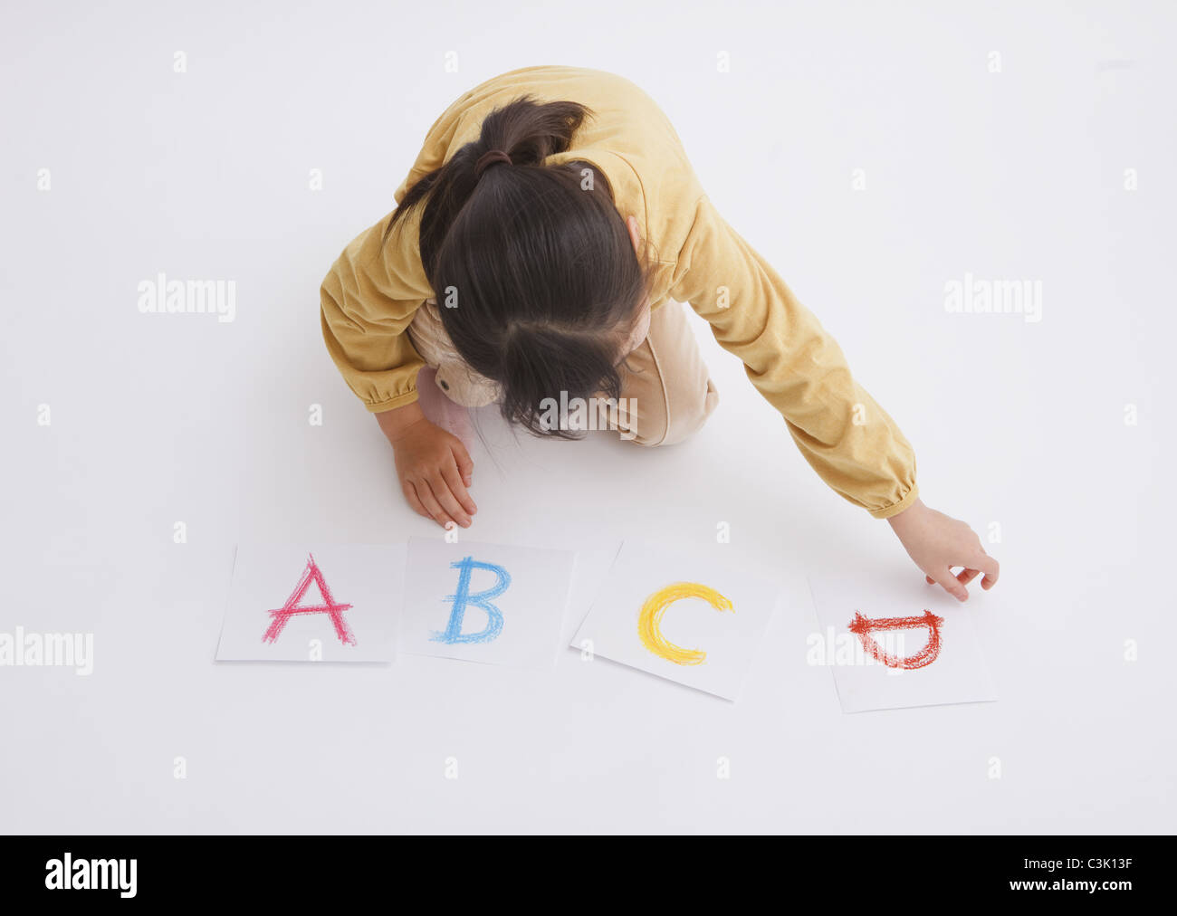 Girl lining up alphabet cards Stock Photo - Alamy