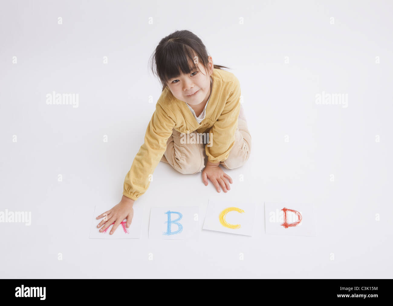 Girl lining up alphabet cards Stock Photo - Alamy