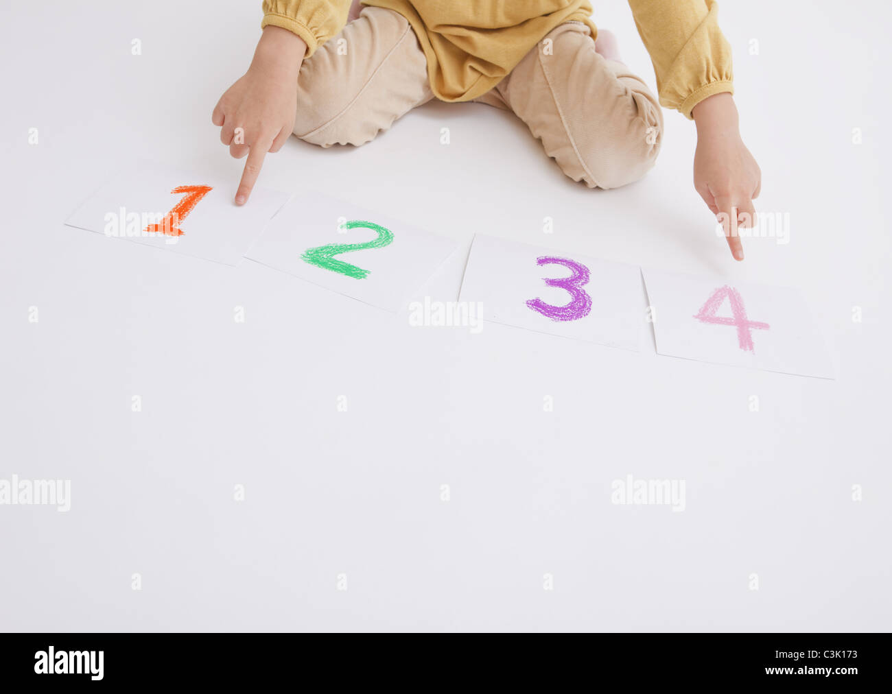 Girl pointing at number cards Stock Photo - Alamy