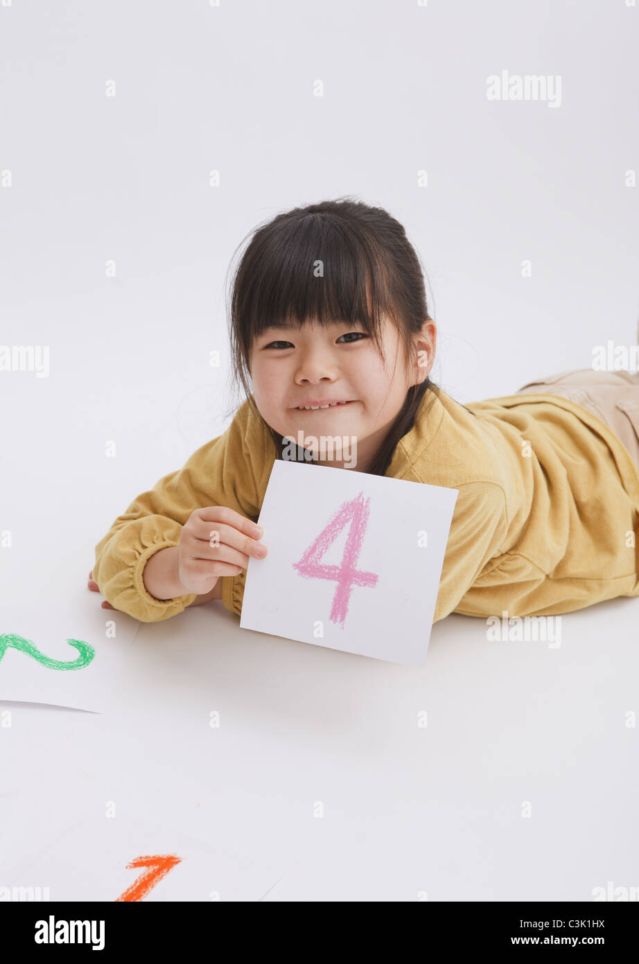 Girl holding number cards Stock Photo - Alamy