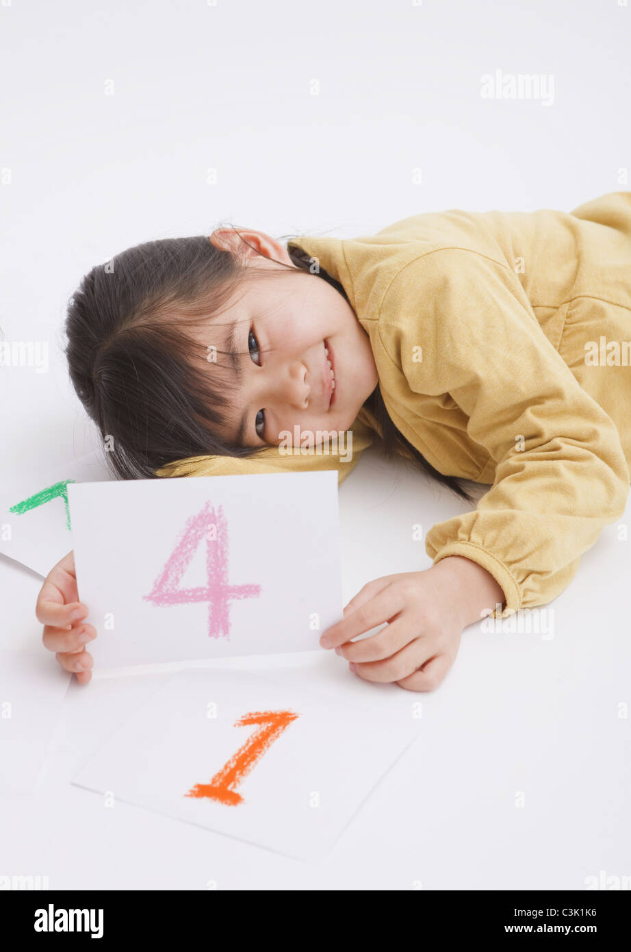 Girl holding number cards Stock Photo - Alamy