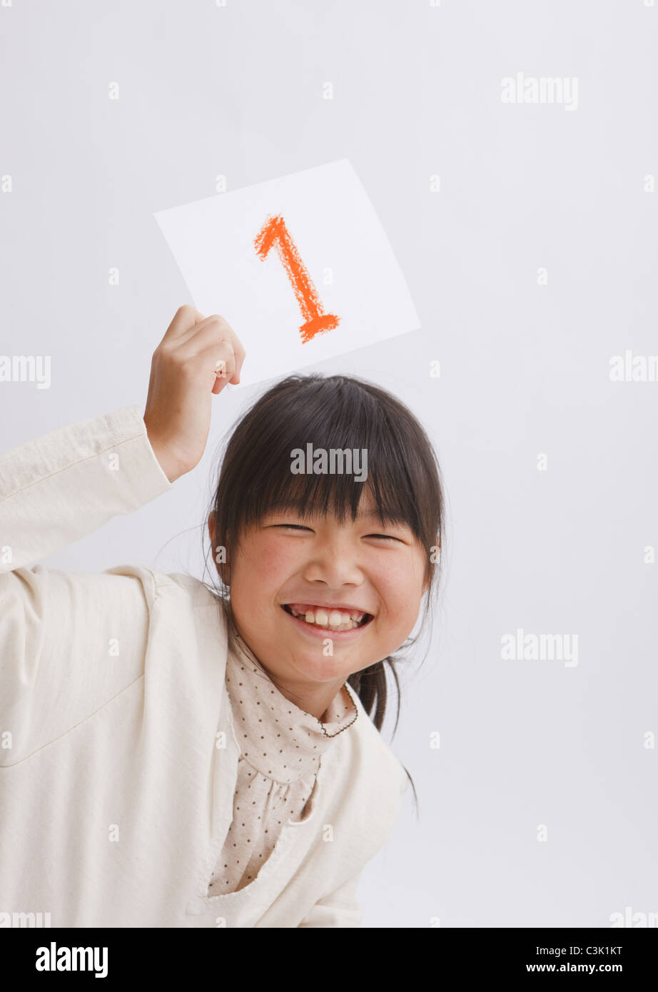 Girl holding up number cards Stock Photo - Alamy