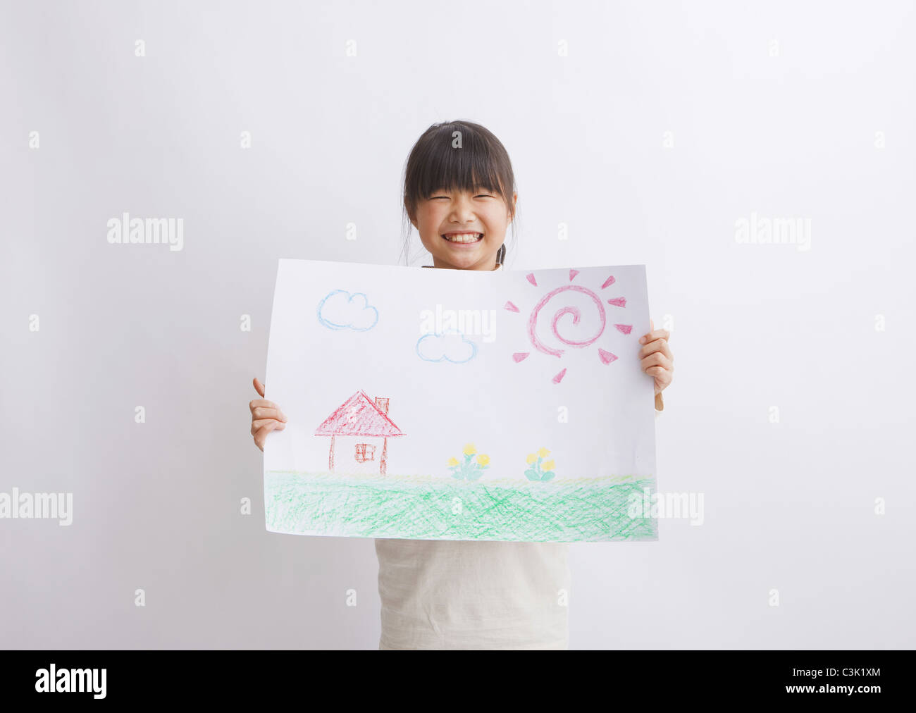 Girl holding drawing Stock Photo - Alamy