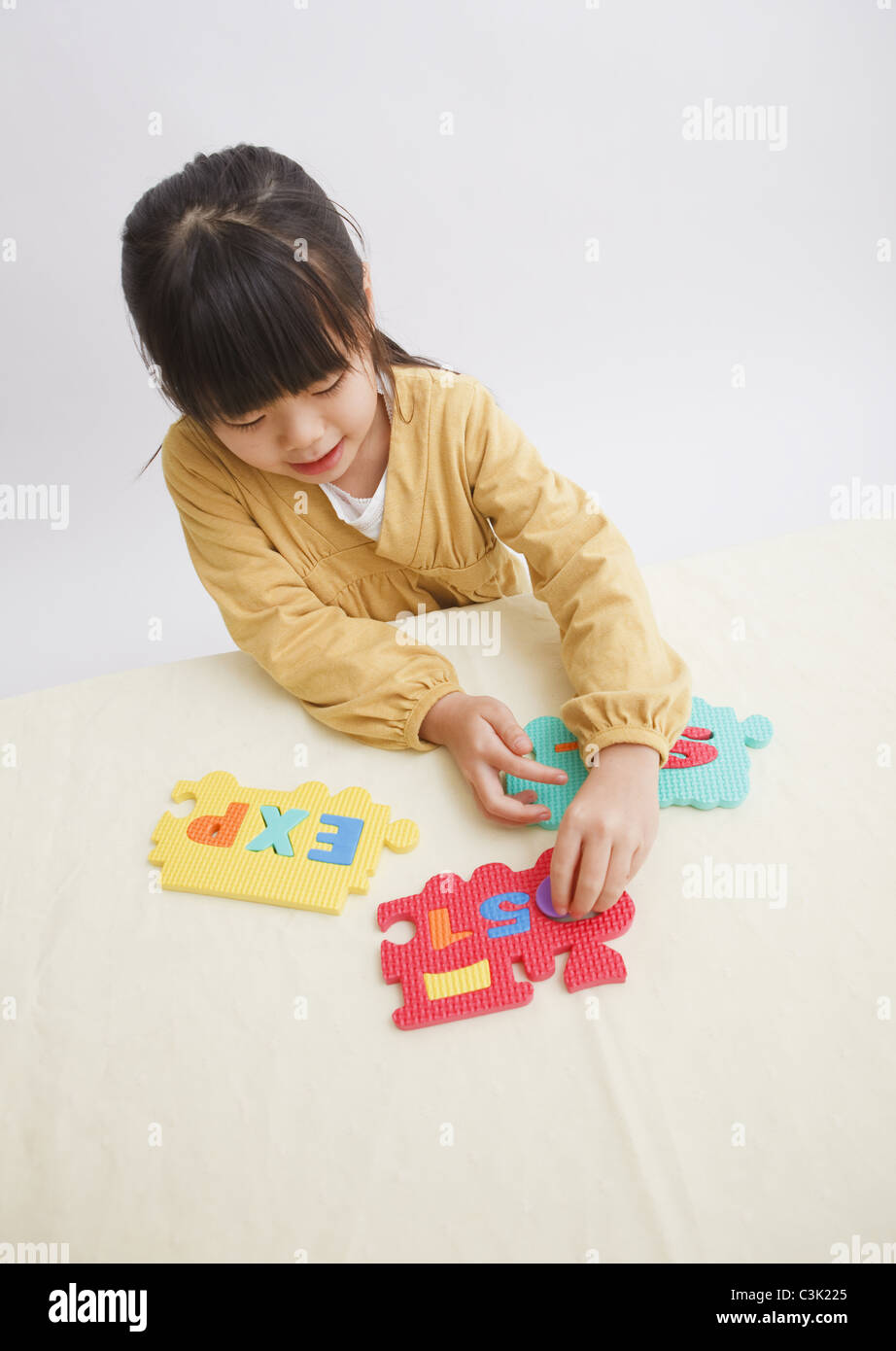 Girl playing puzzle Stock Photo - Alamy