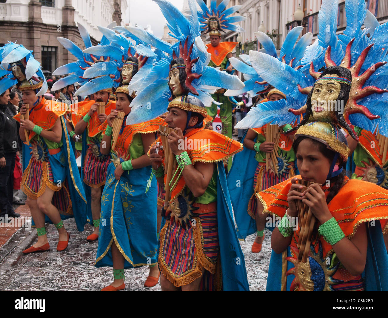 Groups of indigenous dancers and musicians parade through the streets ...