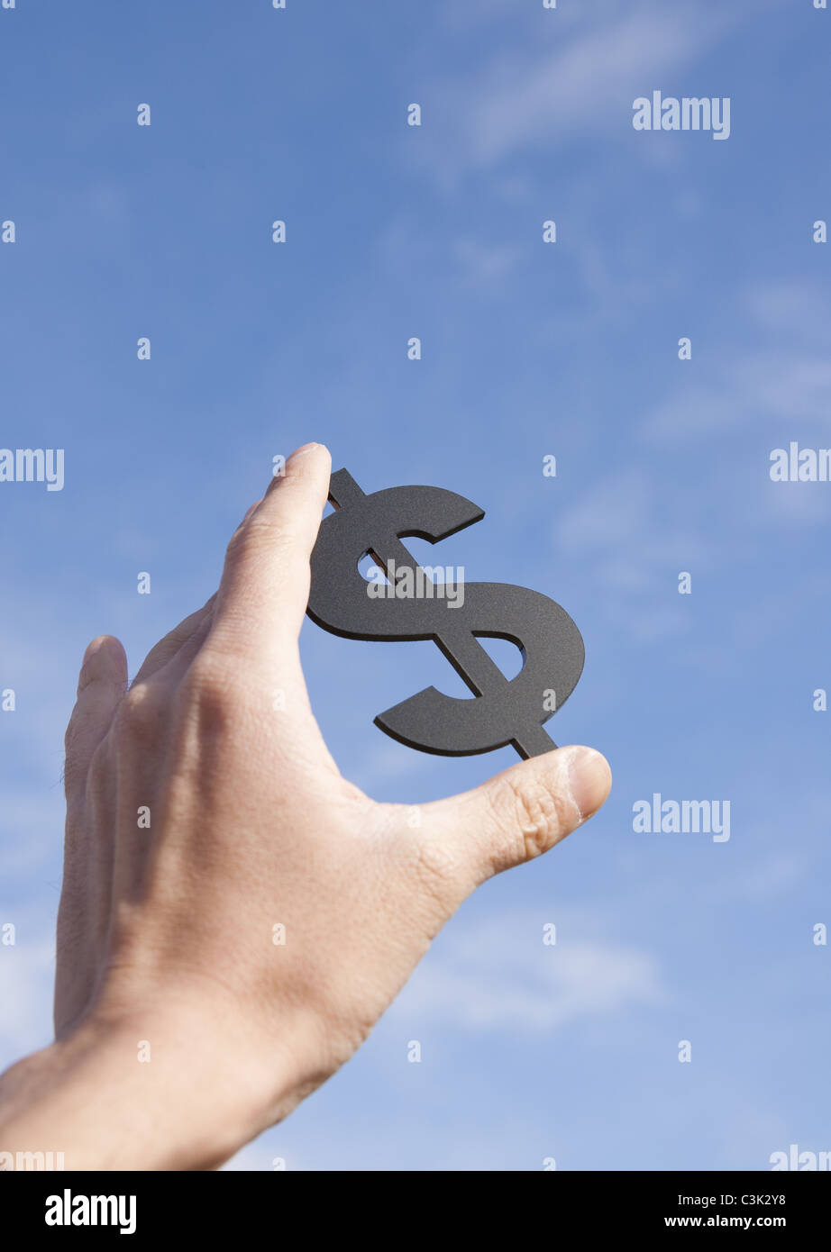Hand holding dollar sign Stock Photo - Alamy