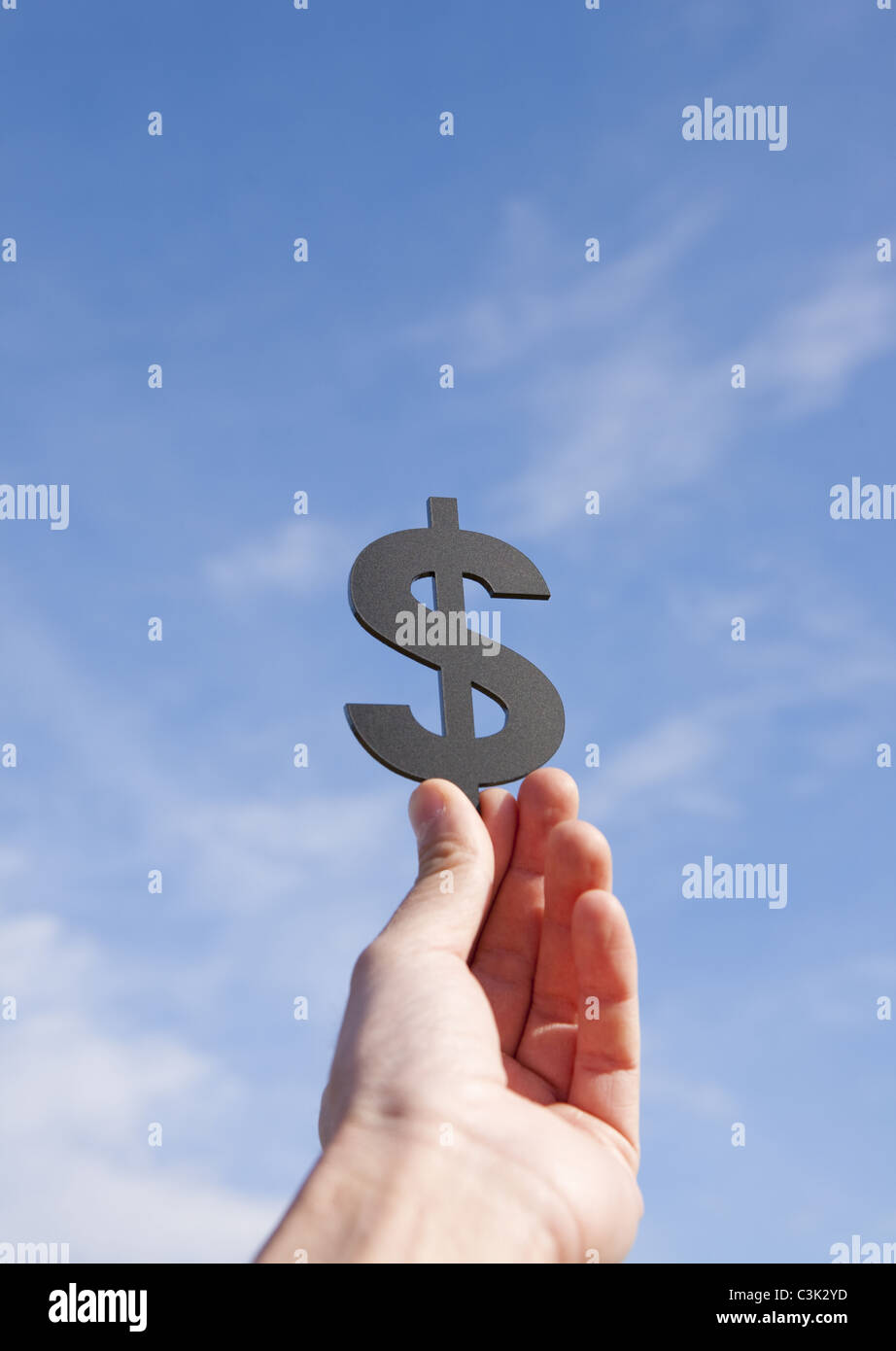 Hand holding dollar sign Stock Photo - Alamy