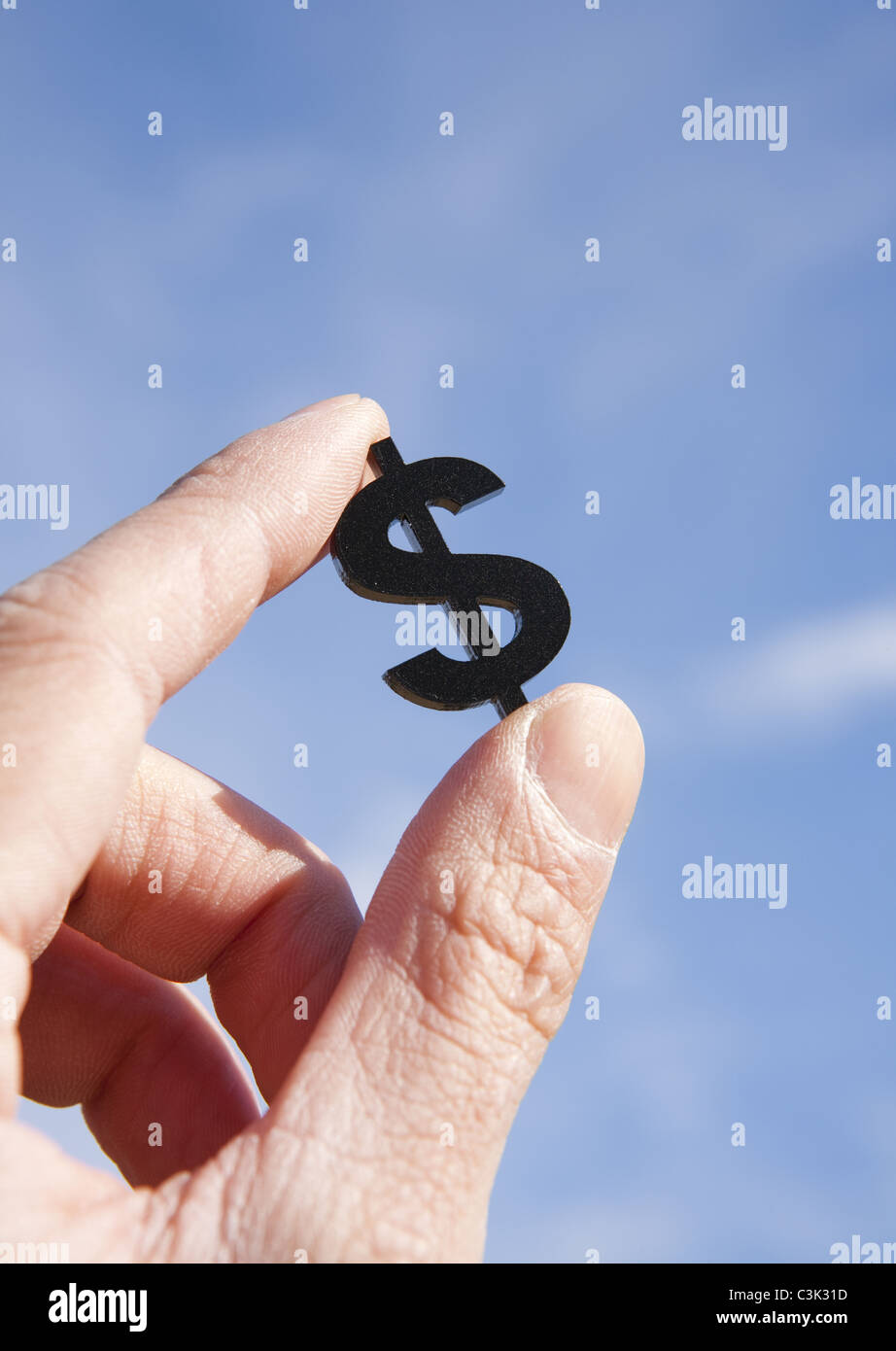Hand holding dollar sign Stock Photo - Alamy