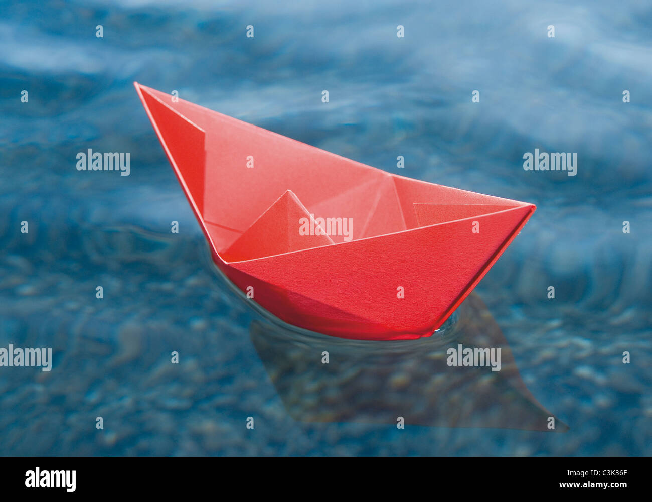 Germany, Paper boat floating on water, close up Stock Photo - Alamy