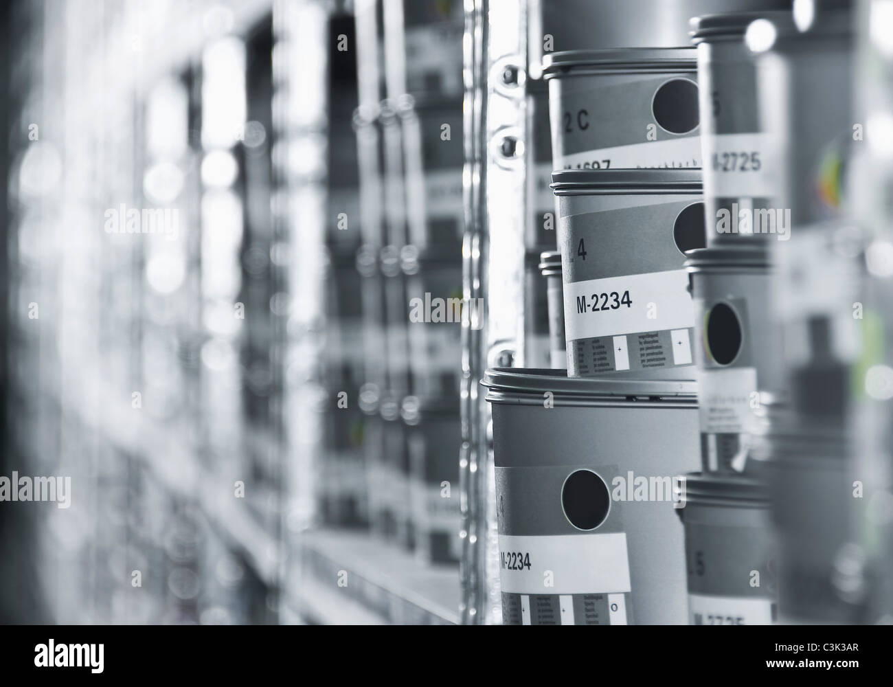 Paint cans in industrial warehouse Stock Photo - Alamy