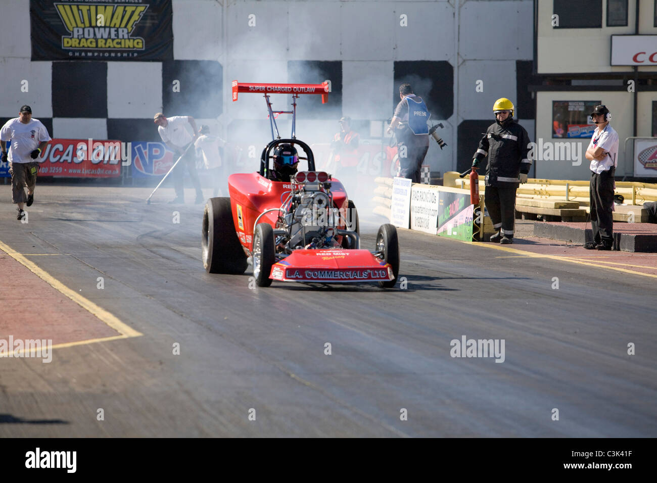 Red dragster pulls off Stock Photo - Alamy