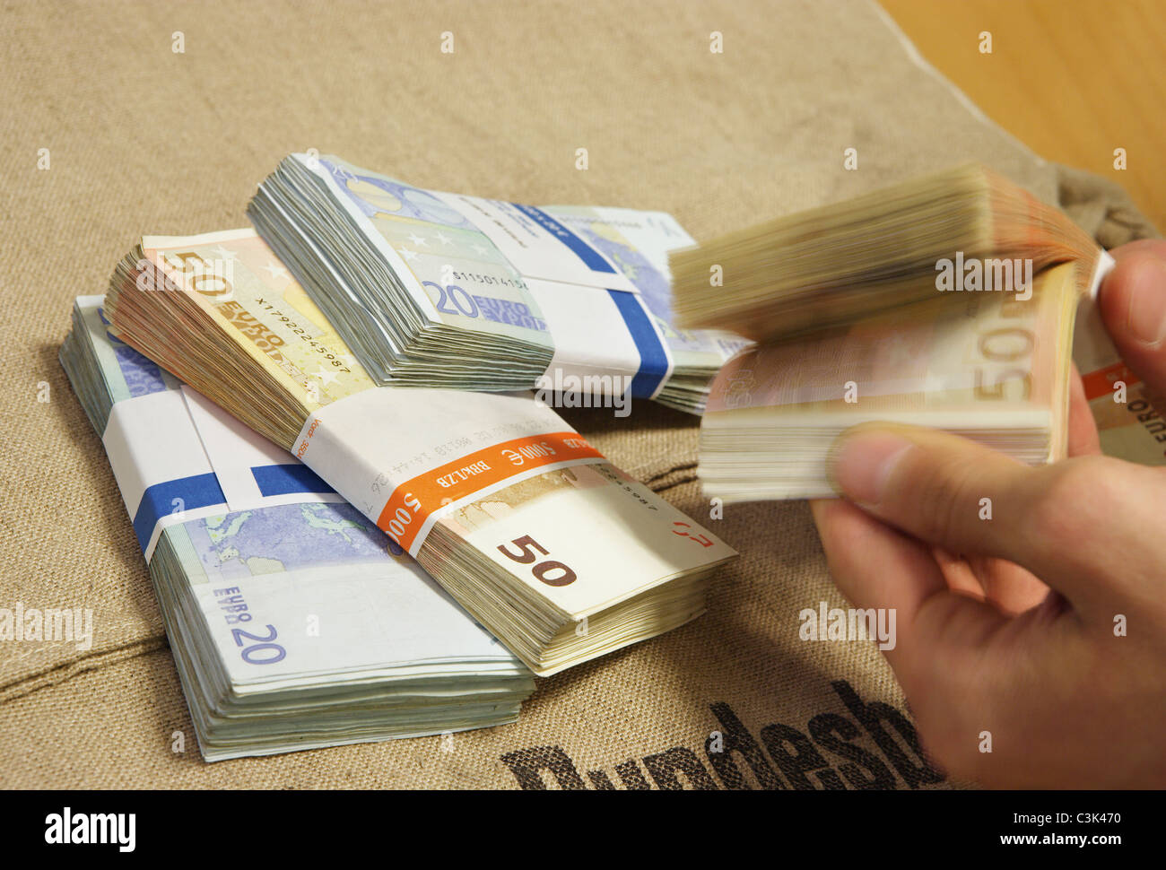 Hand holding bundles money hi-res stock photography and images - Alamy