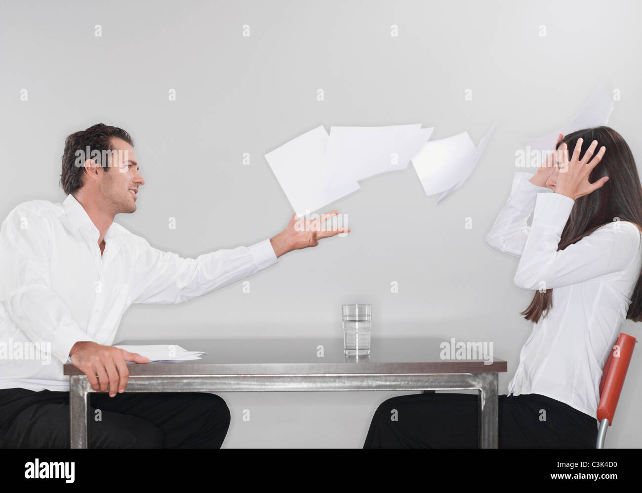 Business man throwing papers with woman head in hand Stock Photo - Alamy