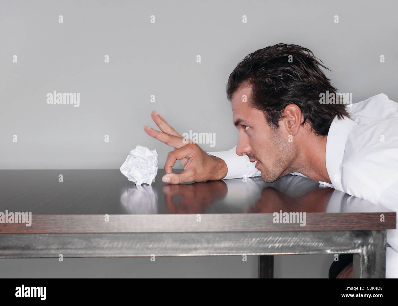 Business man tossing crumpled paper ball Stock Photo - Alamy