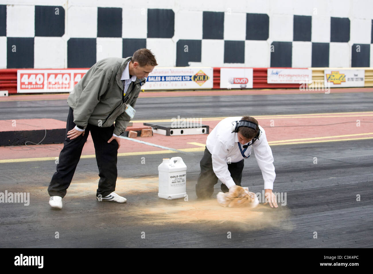 Putting gold dust down after a spillage at the Drag strip Stock Photo ...