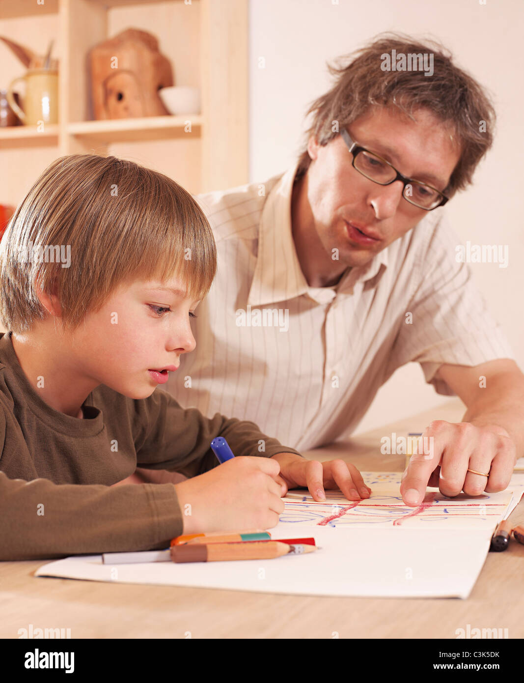 Father and son doing homework Stock Photo - Alamy