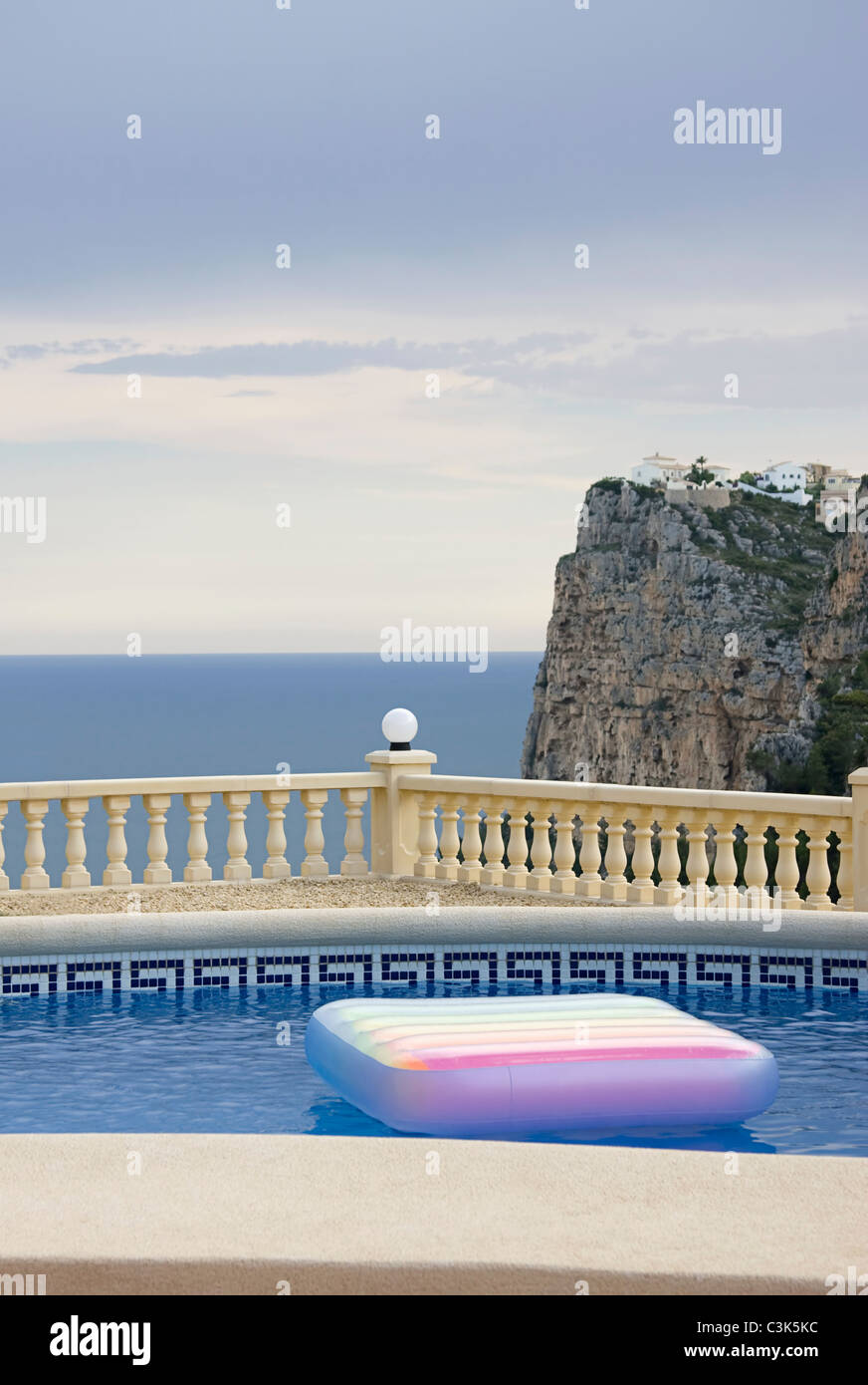 Swimming pool on terrace, sea and cliff in background Stock Photo - Alamy