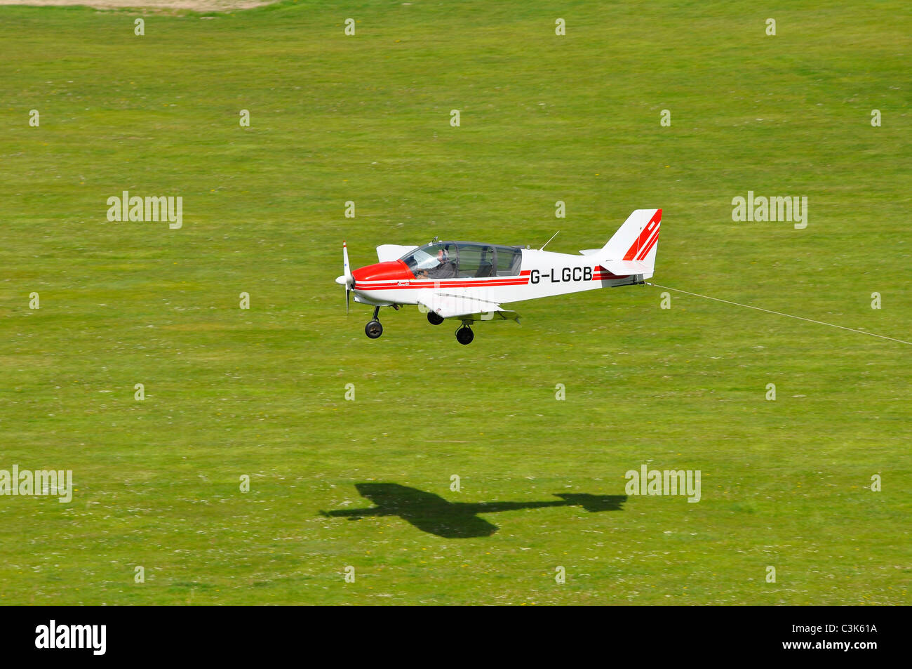 Light Airplane landing on grass with tow rope attached at the London ...