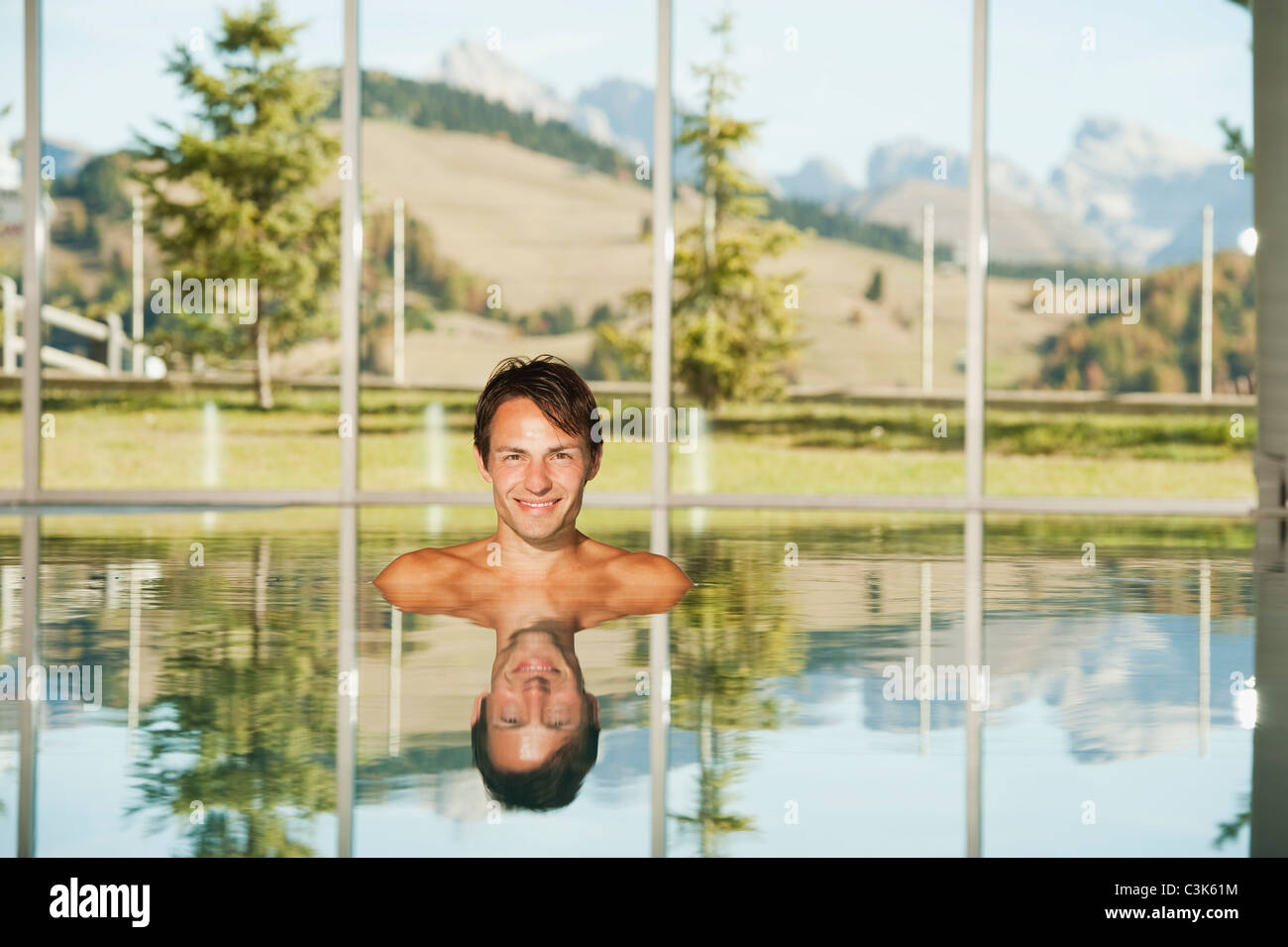 Italy, South Tyrol, Man in swimming pool of hotel urthaler Stock Photo ...