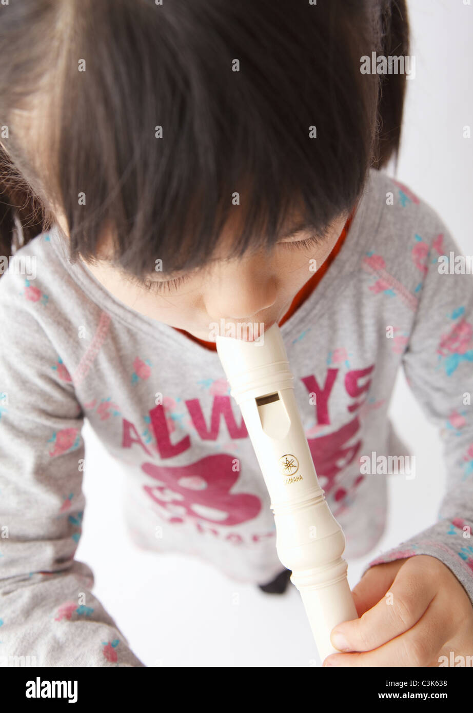 Girl playing recorder Stock Photo - Alamy