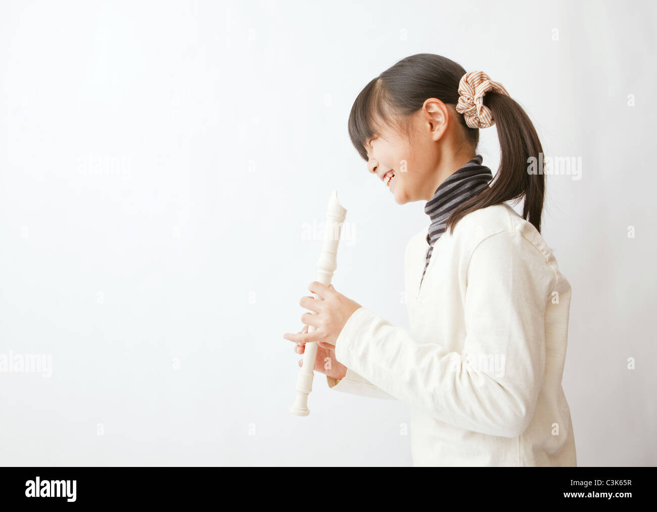 Girl holding recorder Stock Photo - Alamy