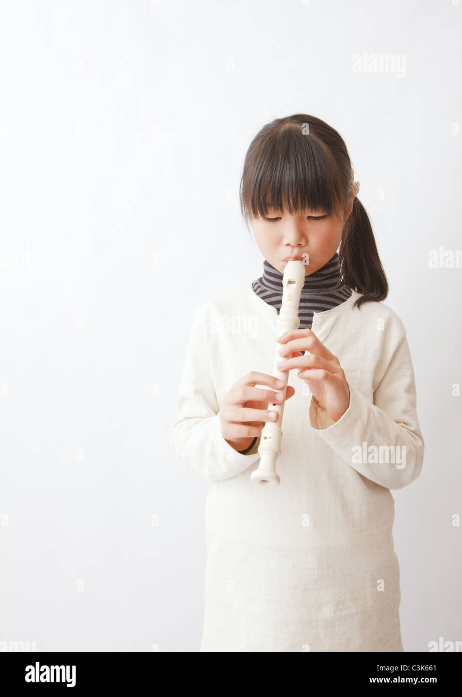 Girl playing recorder Stock Photo - Alamy