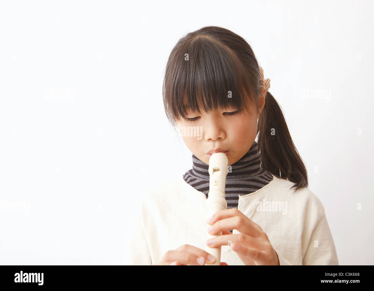 Girl playing recorder Stock Photo - Alamy