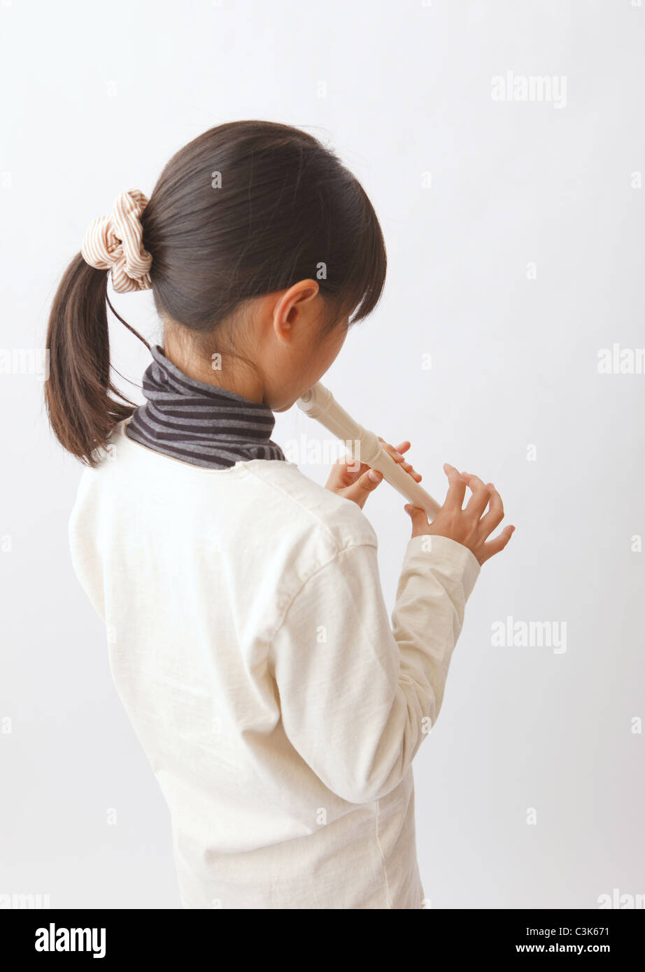 Girl playing recorder Stock Photo - Alamy
