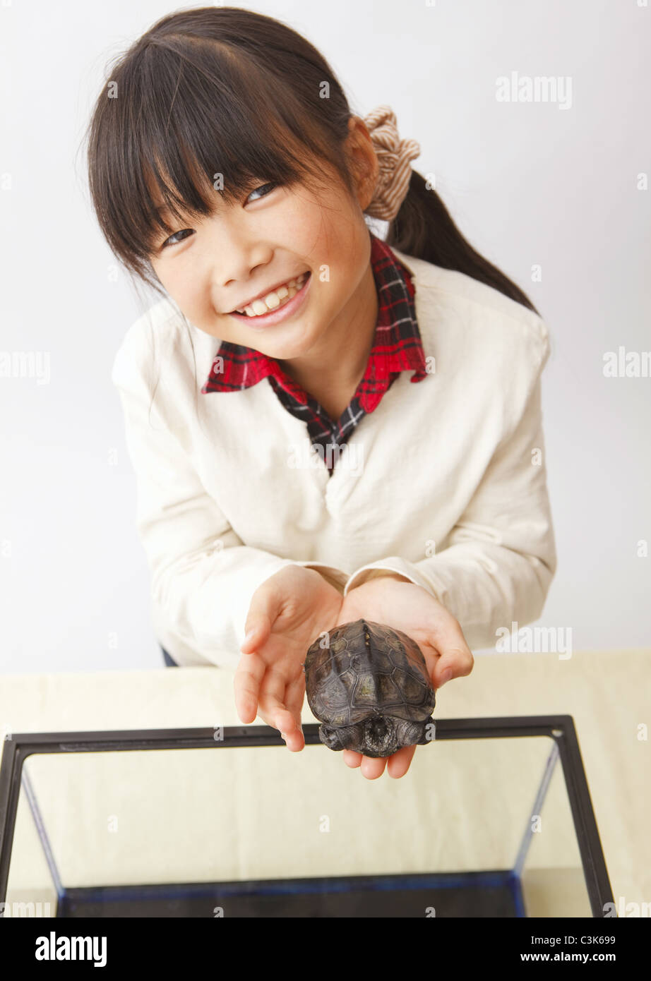 Girl with reeve's turtle Stock Photo - Alamy