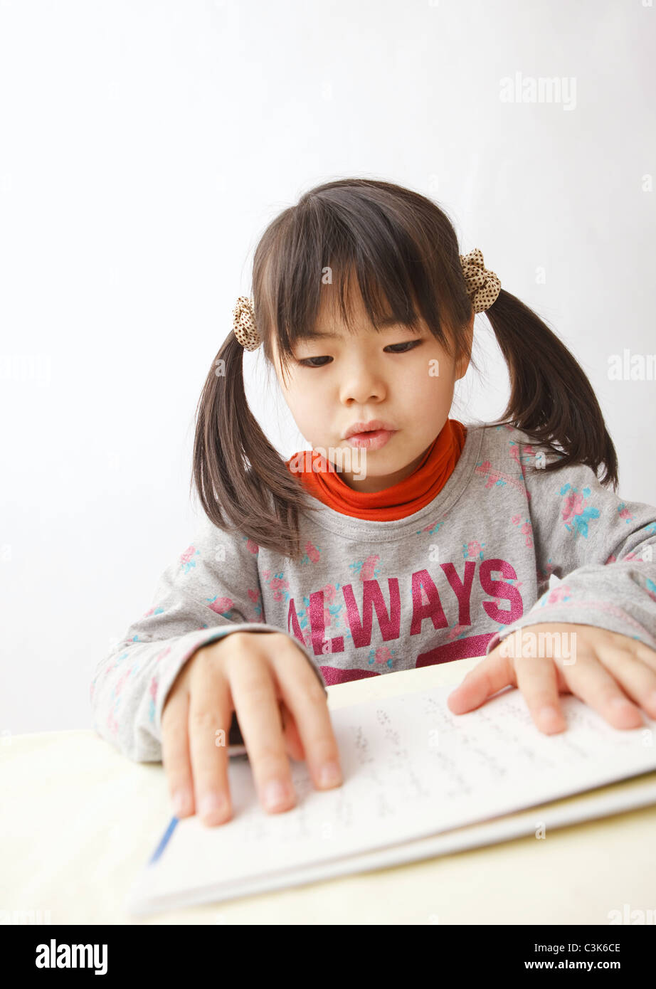 Girl reading book Stock Photo - Alamy