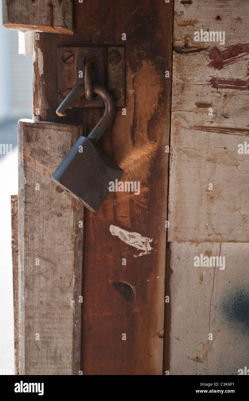 Padlock hanging open on a barn door Stock Photo - Alamy
