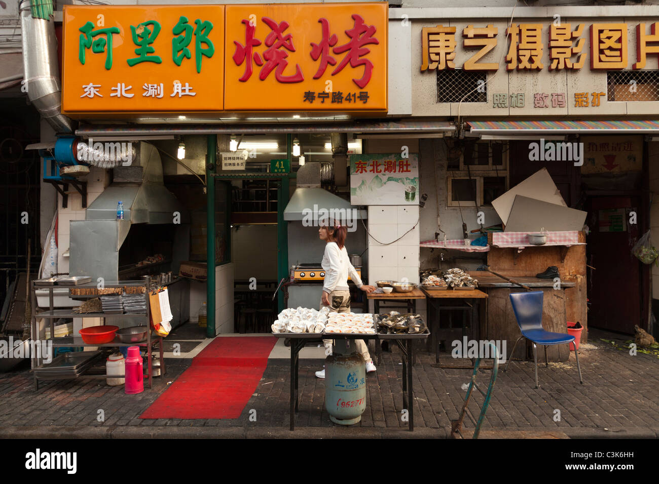 Woman outside a takeaway food stand in Shanghai, China Stock Photo - Alamy