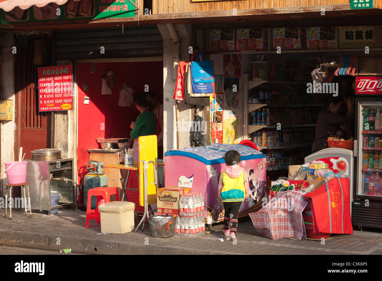 Child entering a colorful shop front in Shanghai, China Stock Photo - Alamy