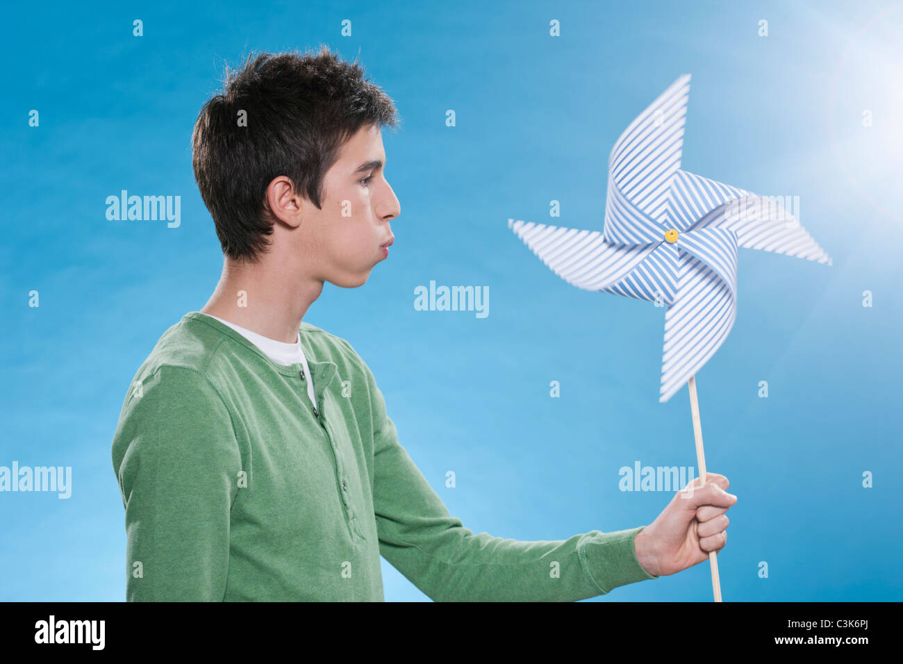 Person blowing paper windmill hi-res stock photography and images - Alamy
