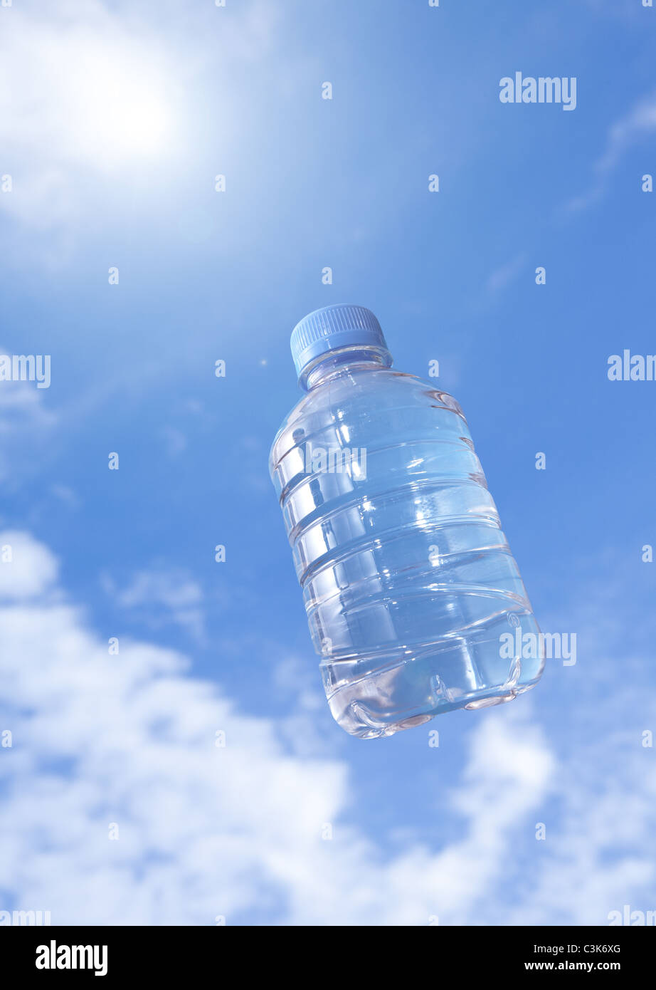 Plastic bottle floating in blue sky Stock Photo - Alamy