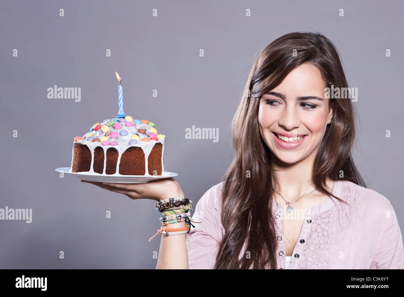 Girl holding cake, smiling Stock Photo - Alamy
