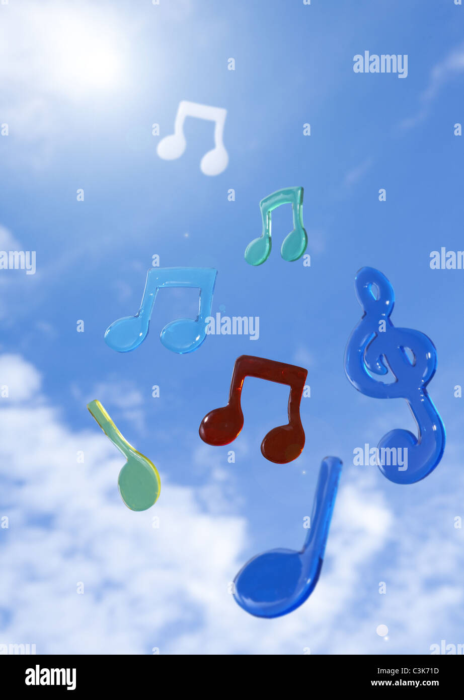 Musical notes floating in blue sky Stock Photo - Alamy
