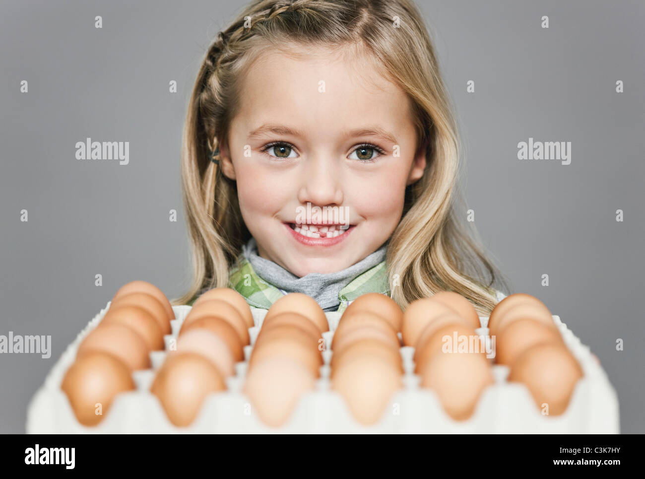 Girl holding egg carton with eggs, portrait Stock Photo - Alamy