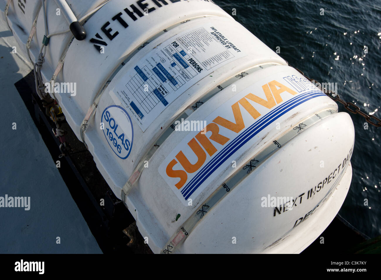 Emergency self deploying and self inflating life raft on a ship deck ...