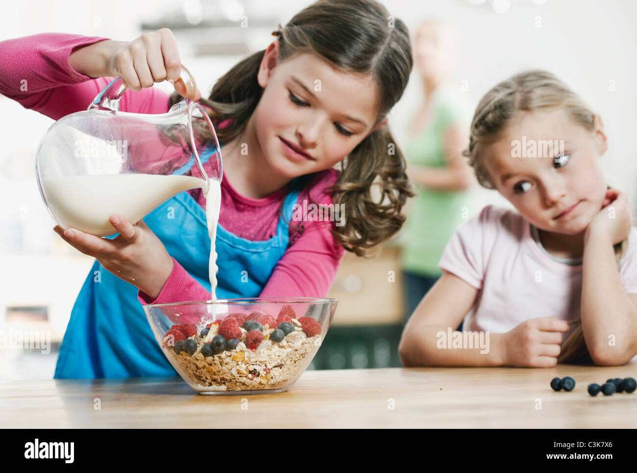 Germany, Cologne, Children preparing breakfast in kitchen Stock Photo ...