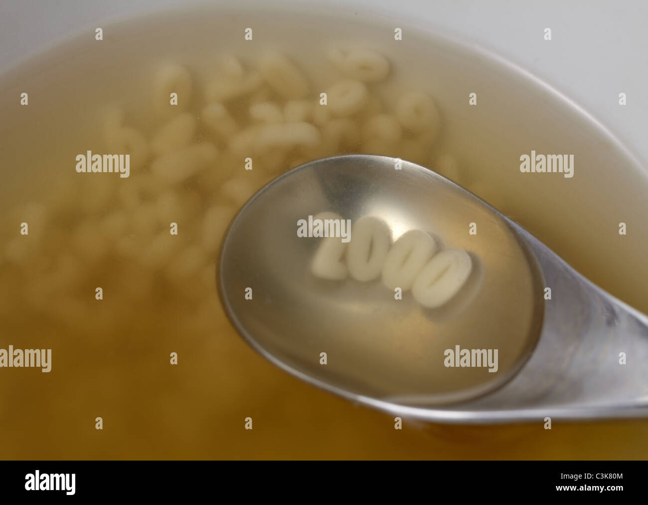 Number shaped macaroni in soup Stock Photo - Alamy