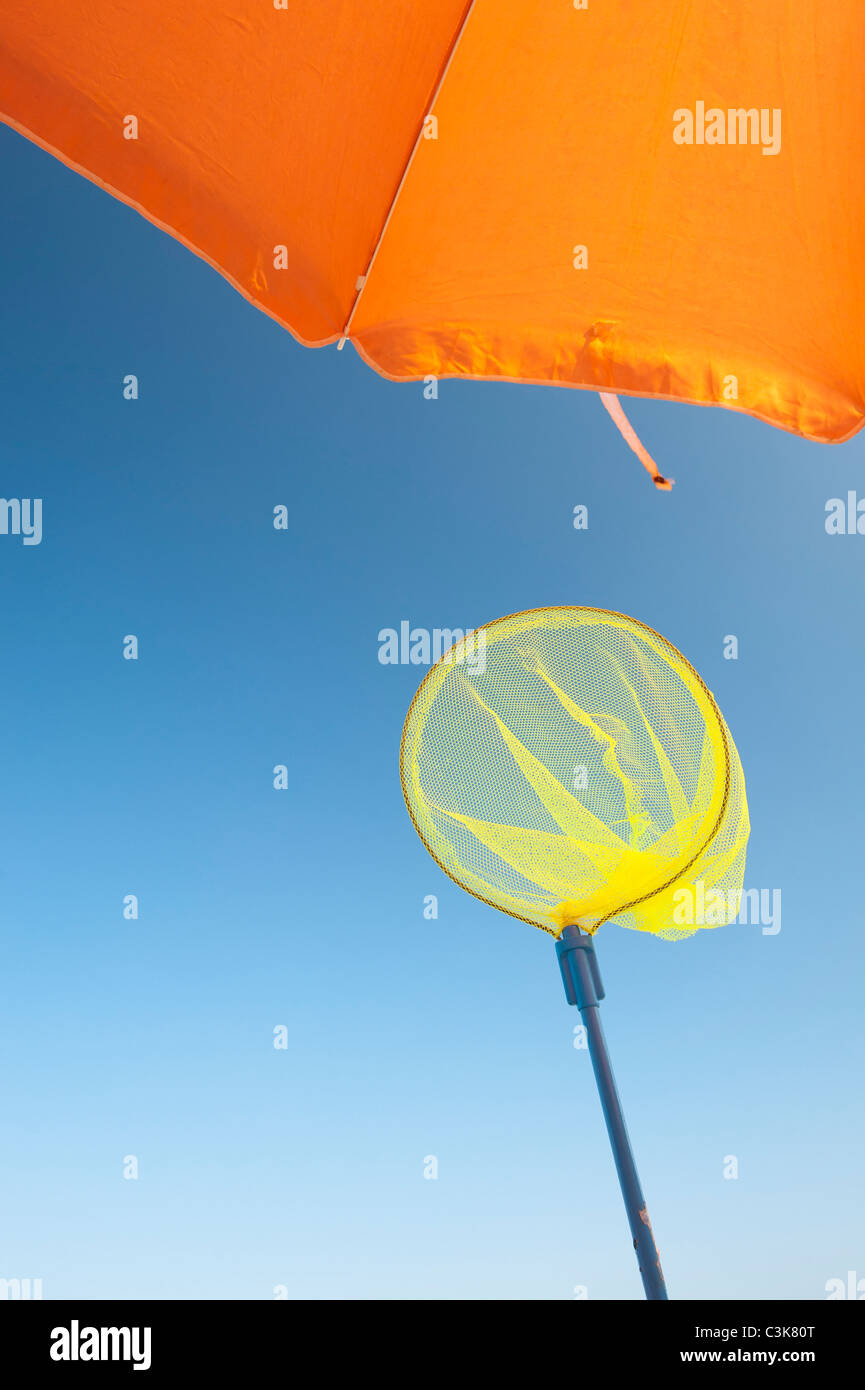 parasol and net against blue sky Stock Photo - Alamy