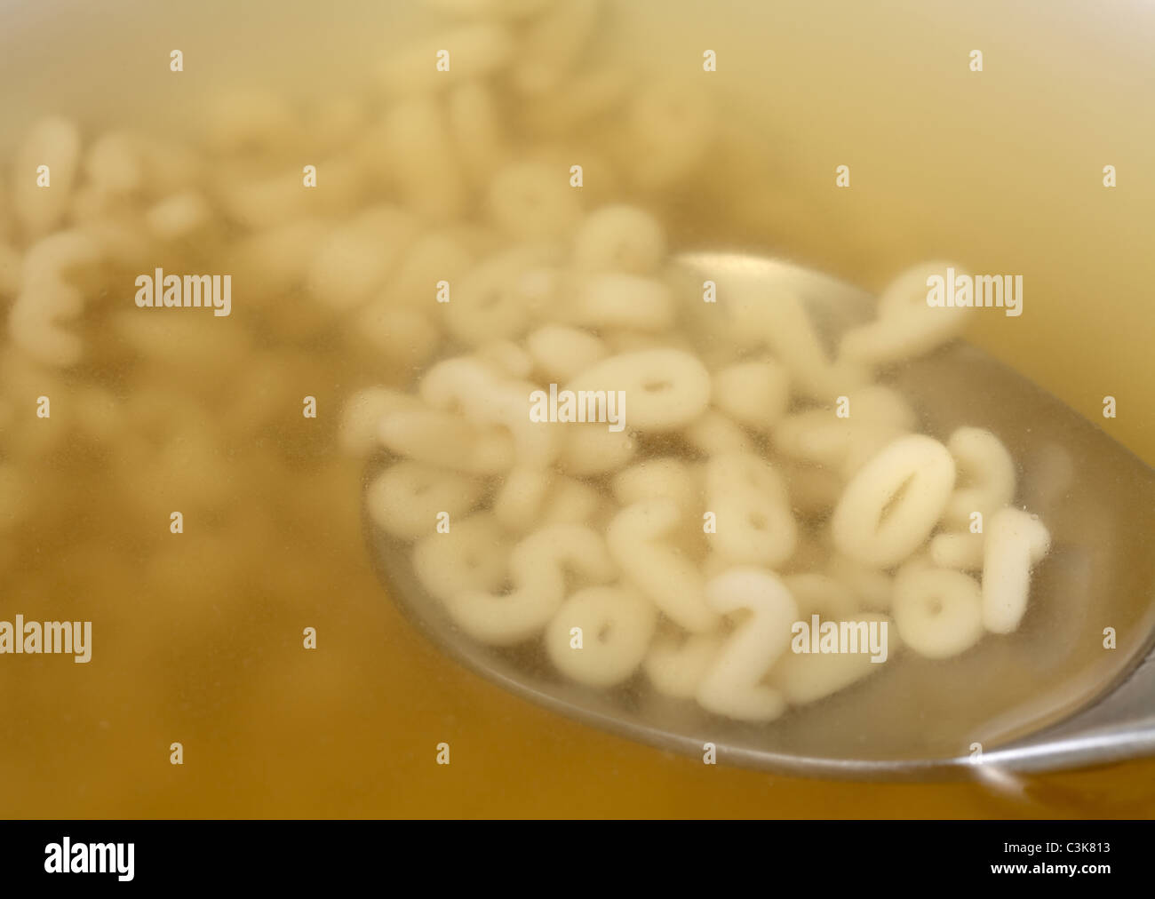 Number shaped macaroni in soup Stock Photo - Alamy