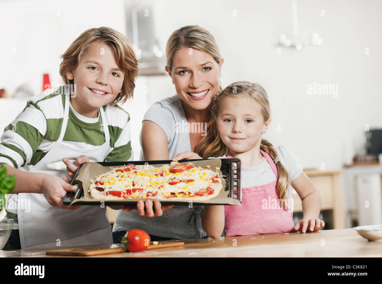 Smiling mother holding pizza hi-res stock photography and images - Alamy